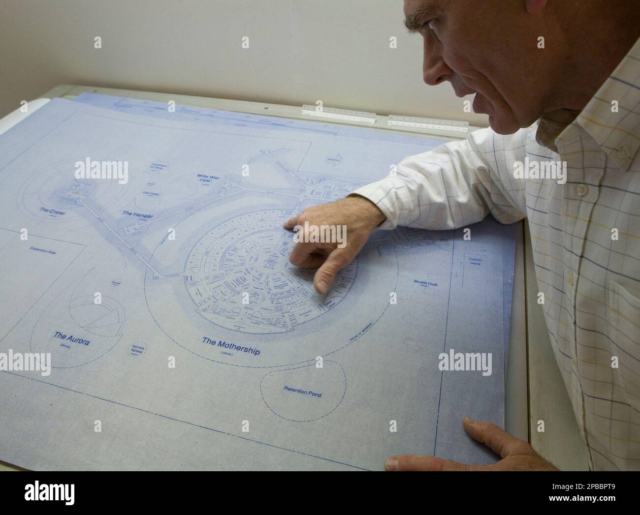 Architect Gene Frazier points May 23, 2007, to details on blueprints of ...