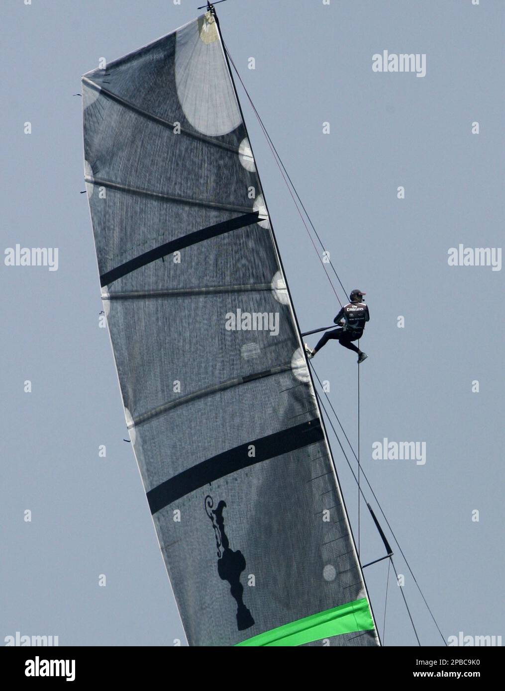 Matt Mason, mast man of Emirates Team New Zealand climbs up the mast at ...