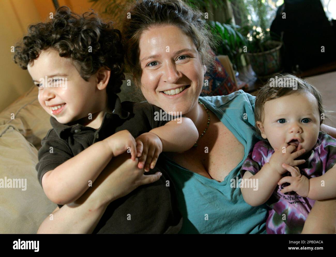 Ruth Katz, 38, is photographed with her sons Julian Rapaport, 2, left ...