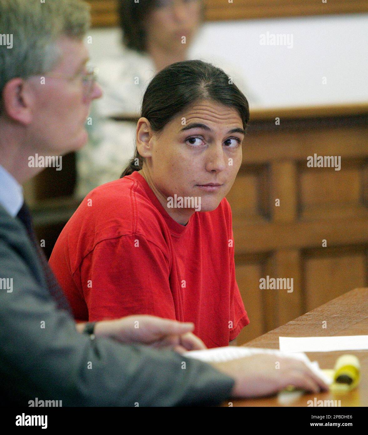 Melanie Paquette Cooper looks at her lawyer Paul McDonough during her ...