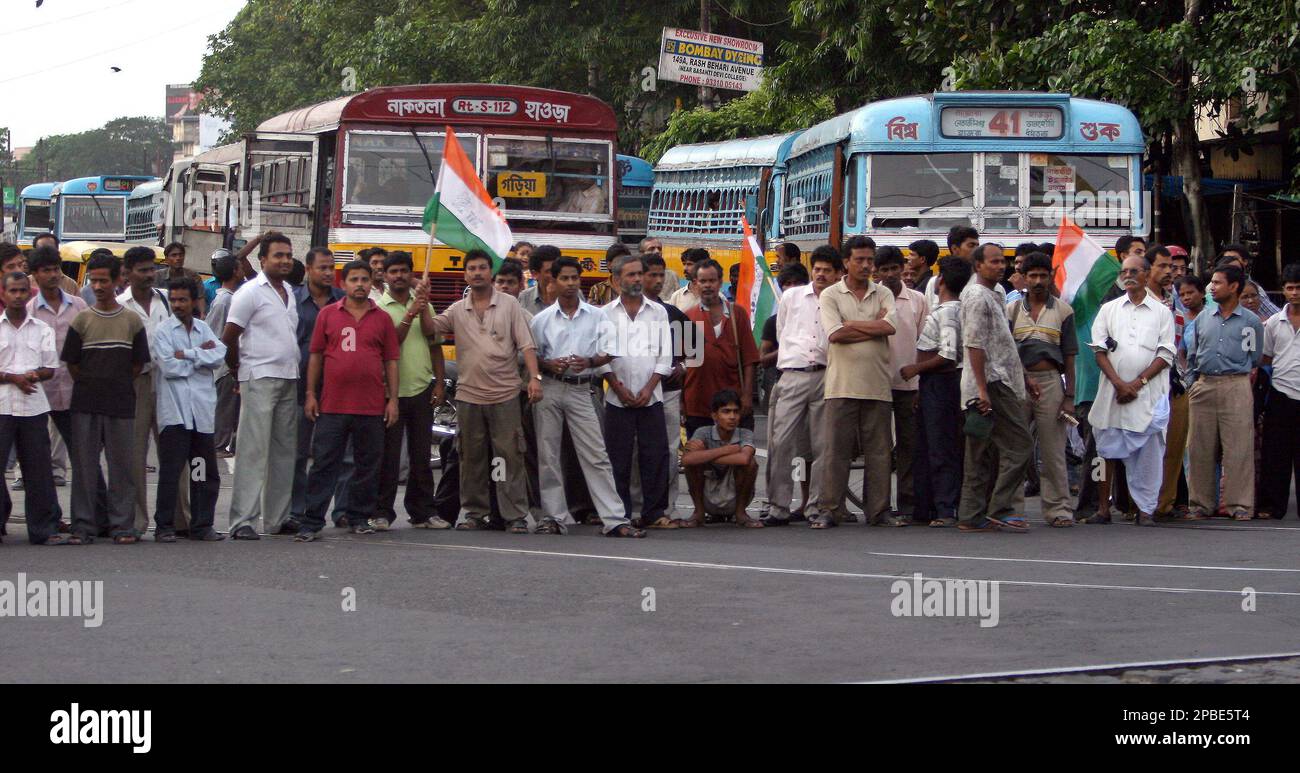 Activists of Trinamul Congress party shout slogans as they stop traffic ...