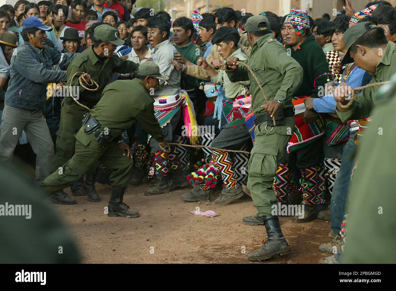 Police officers try to control a crowd of Quechua fighters during ...