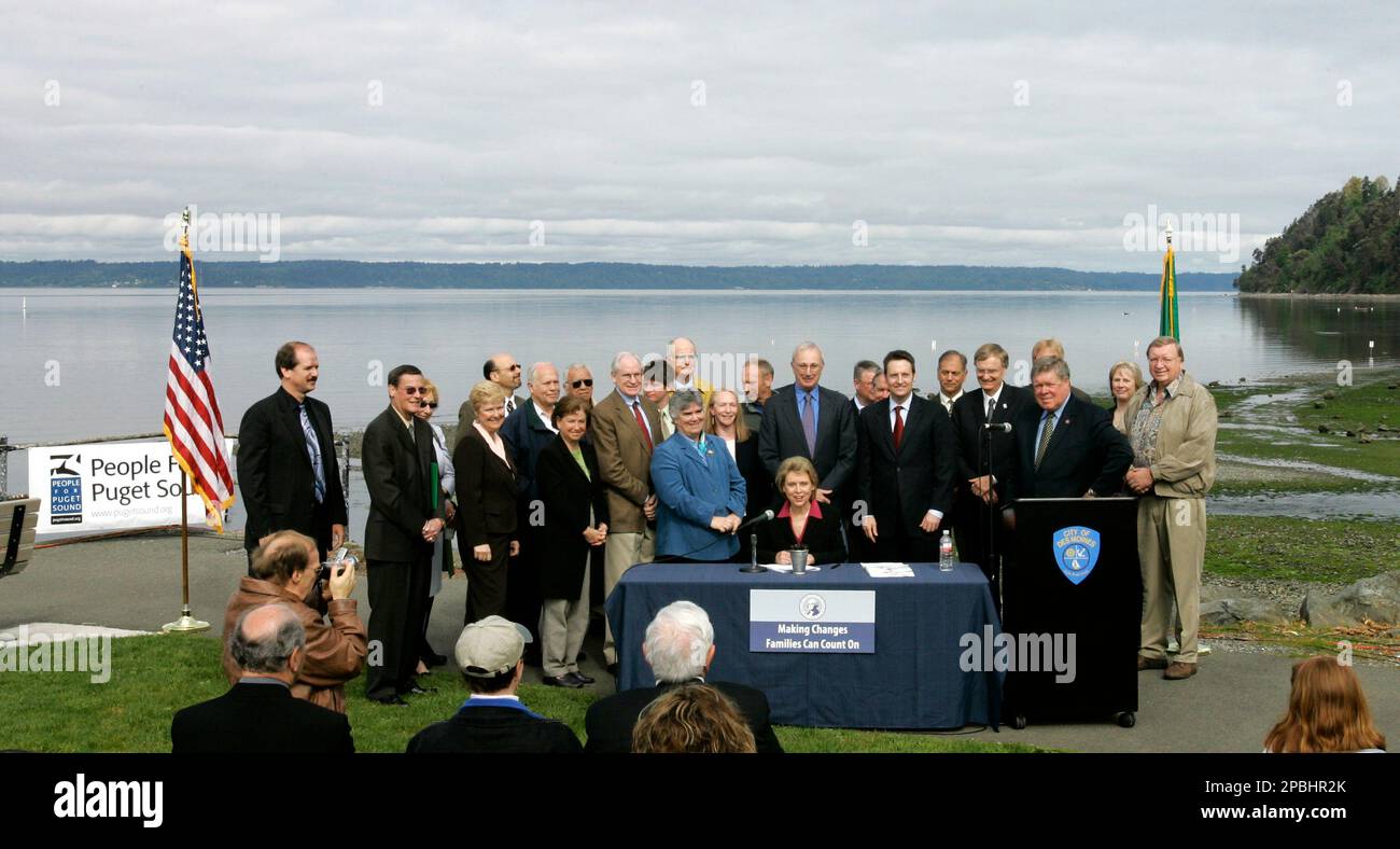 Washington Gov. Chris Gregoire, center, signs legislation Monday, May 7 ...