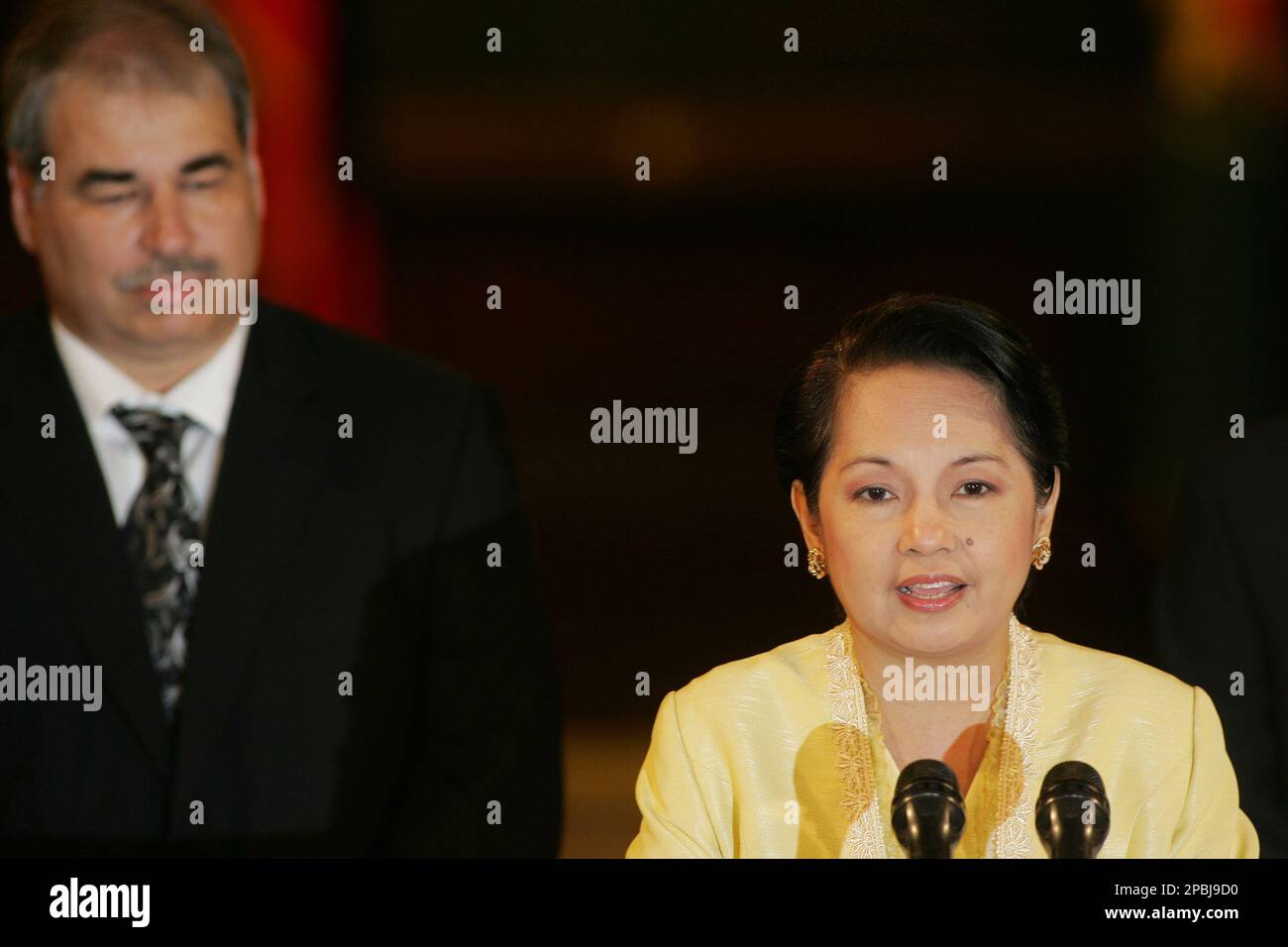 Philippine President Gloria Macapagal Arroyo, right, makes an ...