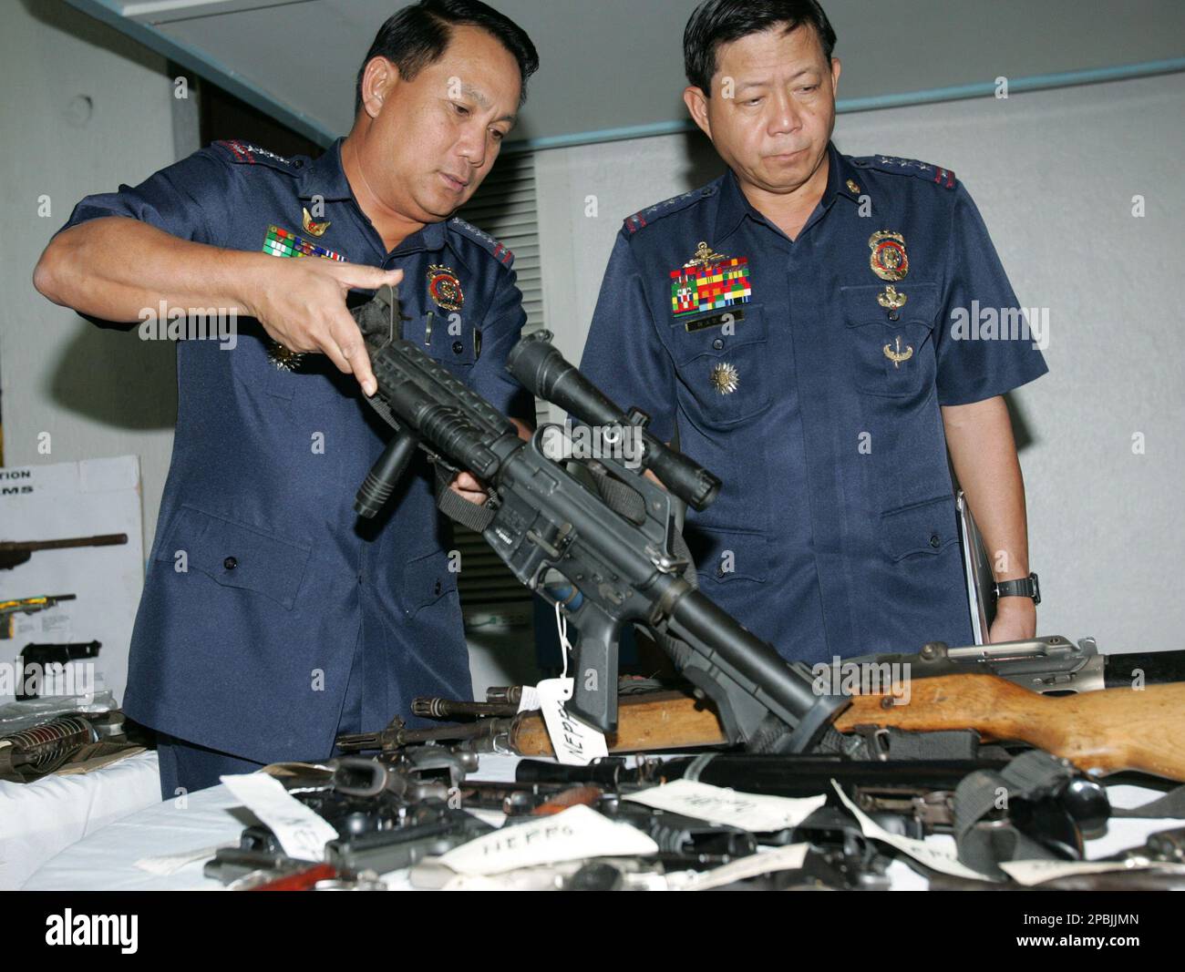 Philippine National Police Chief Gen. Oscar Calderon, left, inspects a ...