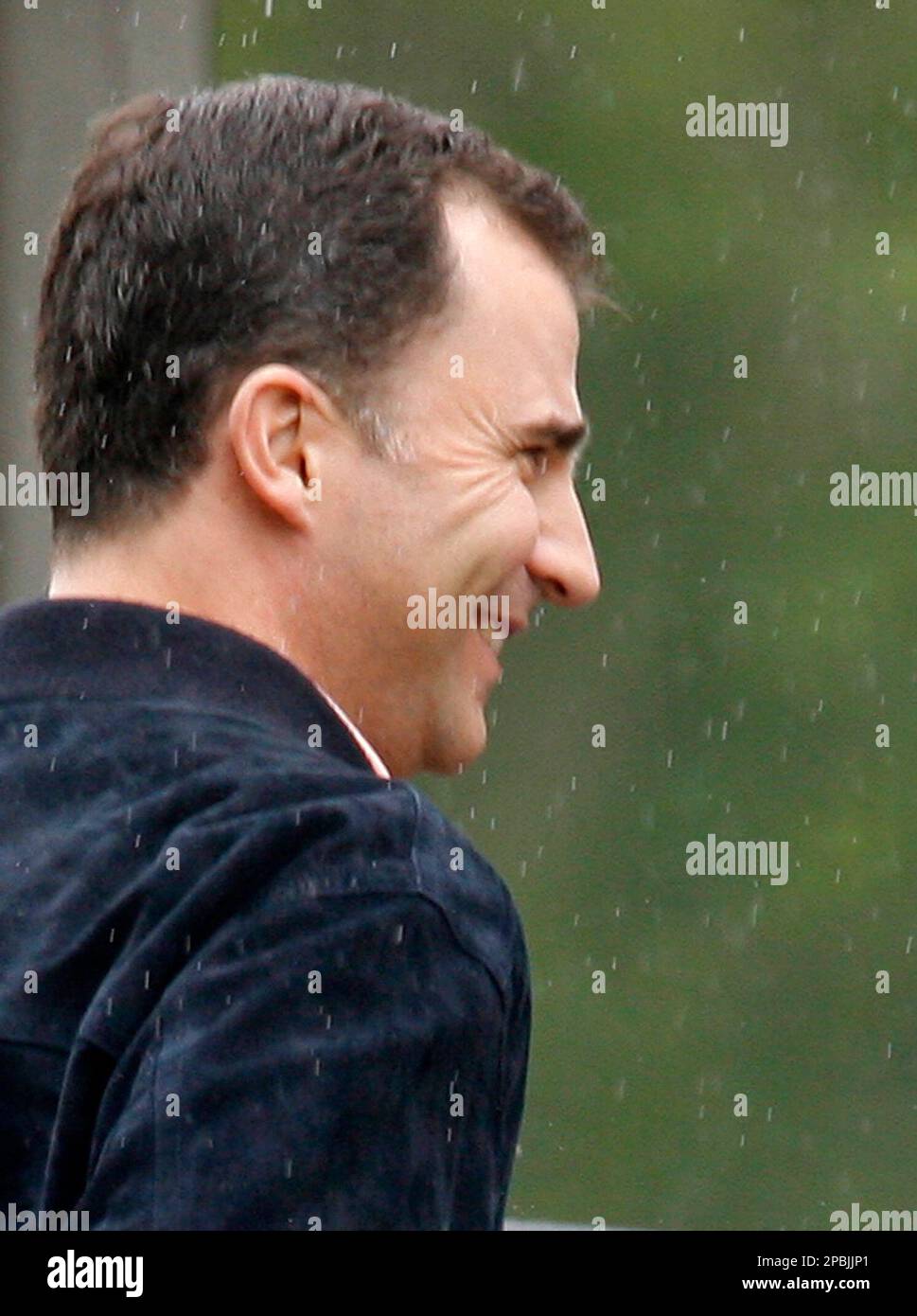 Spain's Crown Prince Felipe smiles under the rain as he arrives to the ...