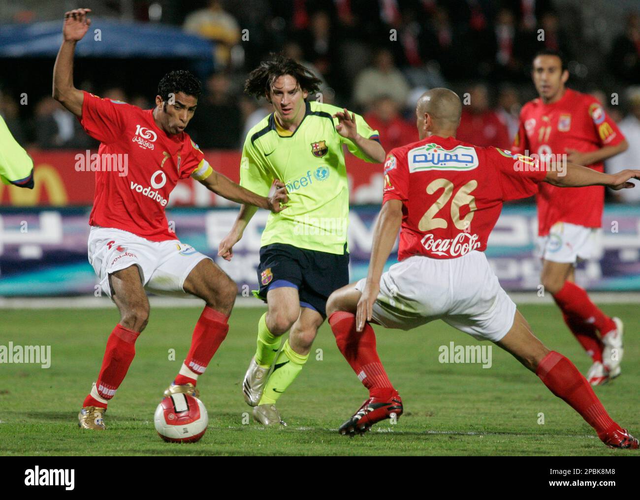 Barcelona's Lionel Messi, center, fights for possession with Al-Ahly's ...