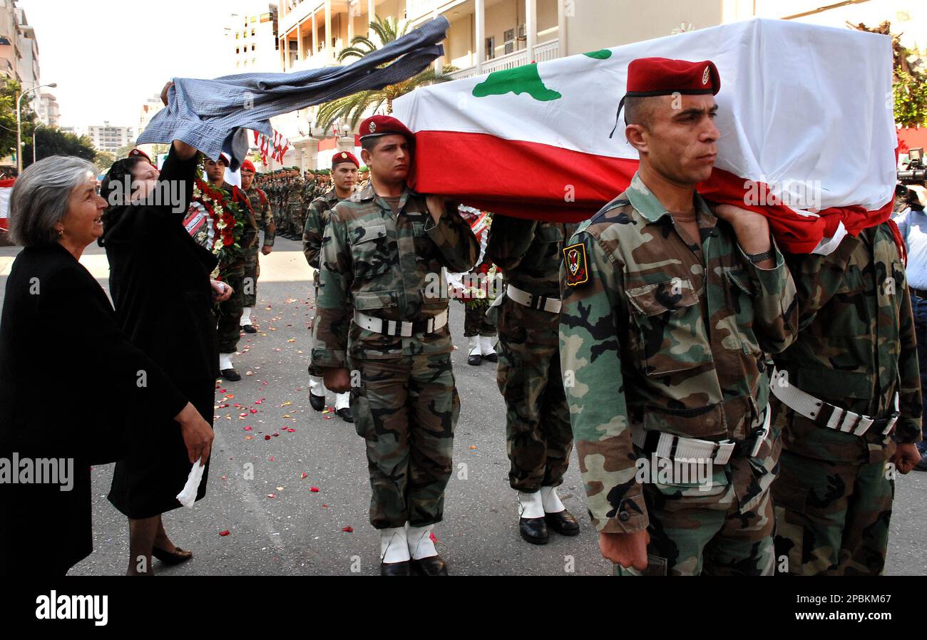 Lebanese soldiers carry the coffins of Youssef Michael el-Hassbani ...