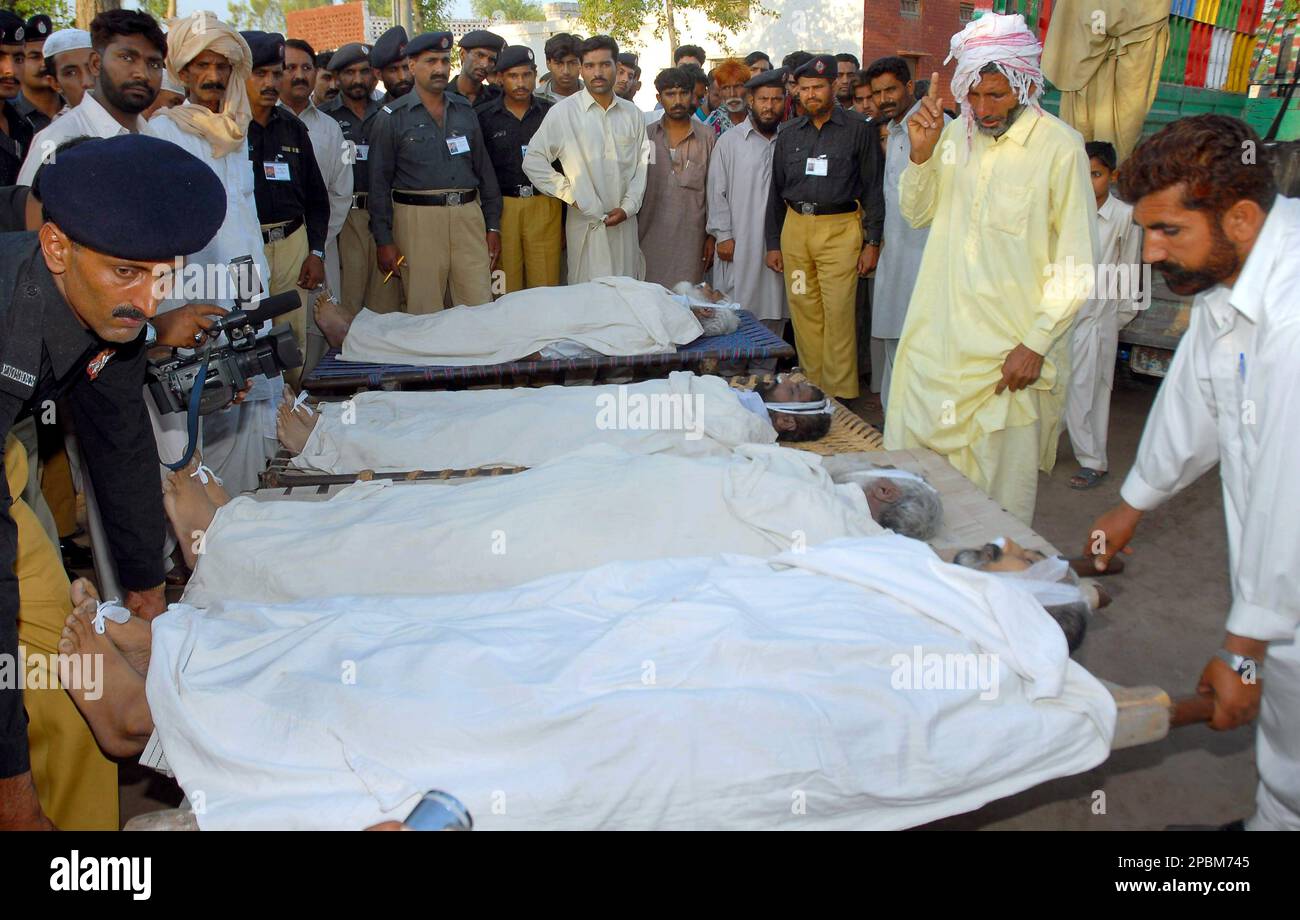Pakistani police officers handover the dead bodies of four executed ...