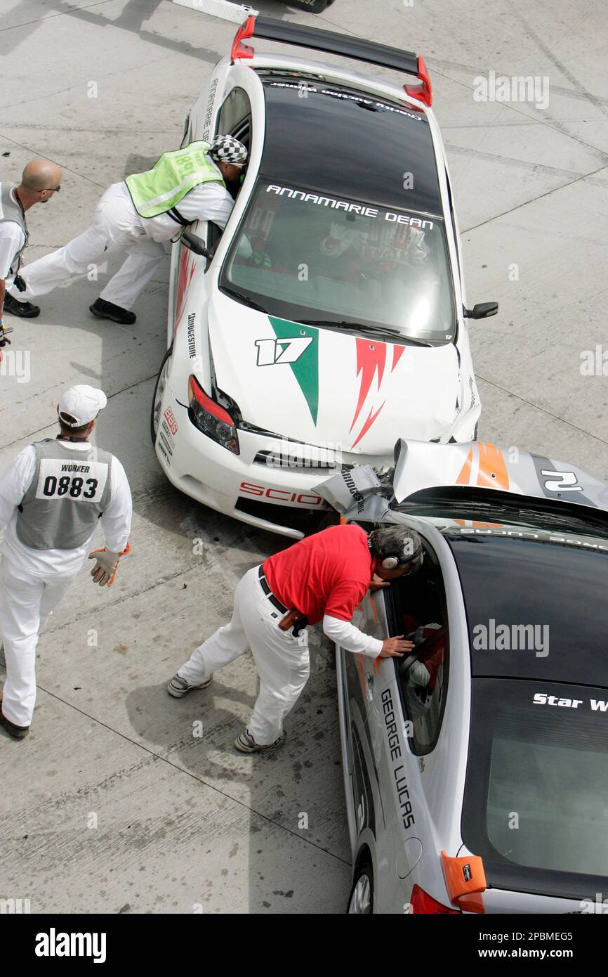Race safety crew check on movie magnate George Lucas in the No. 2 ...