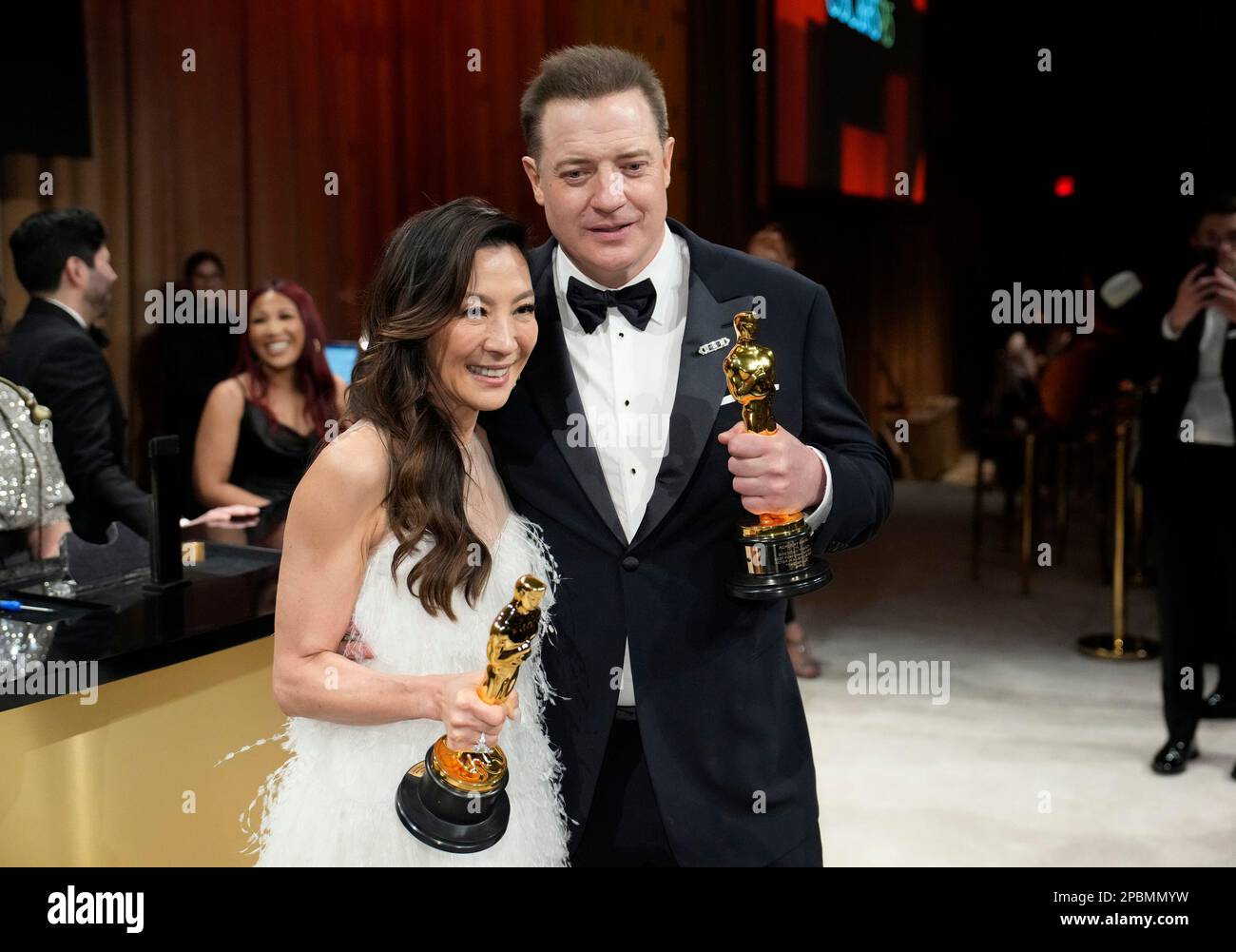 Michelle Yeoh, left, and Brendan Fraser pose with their awards at the ...