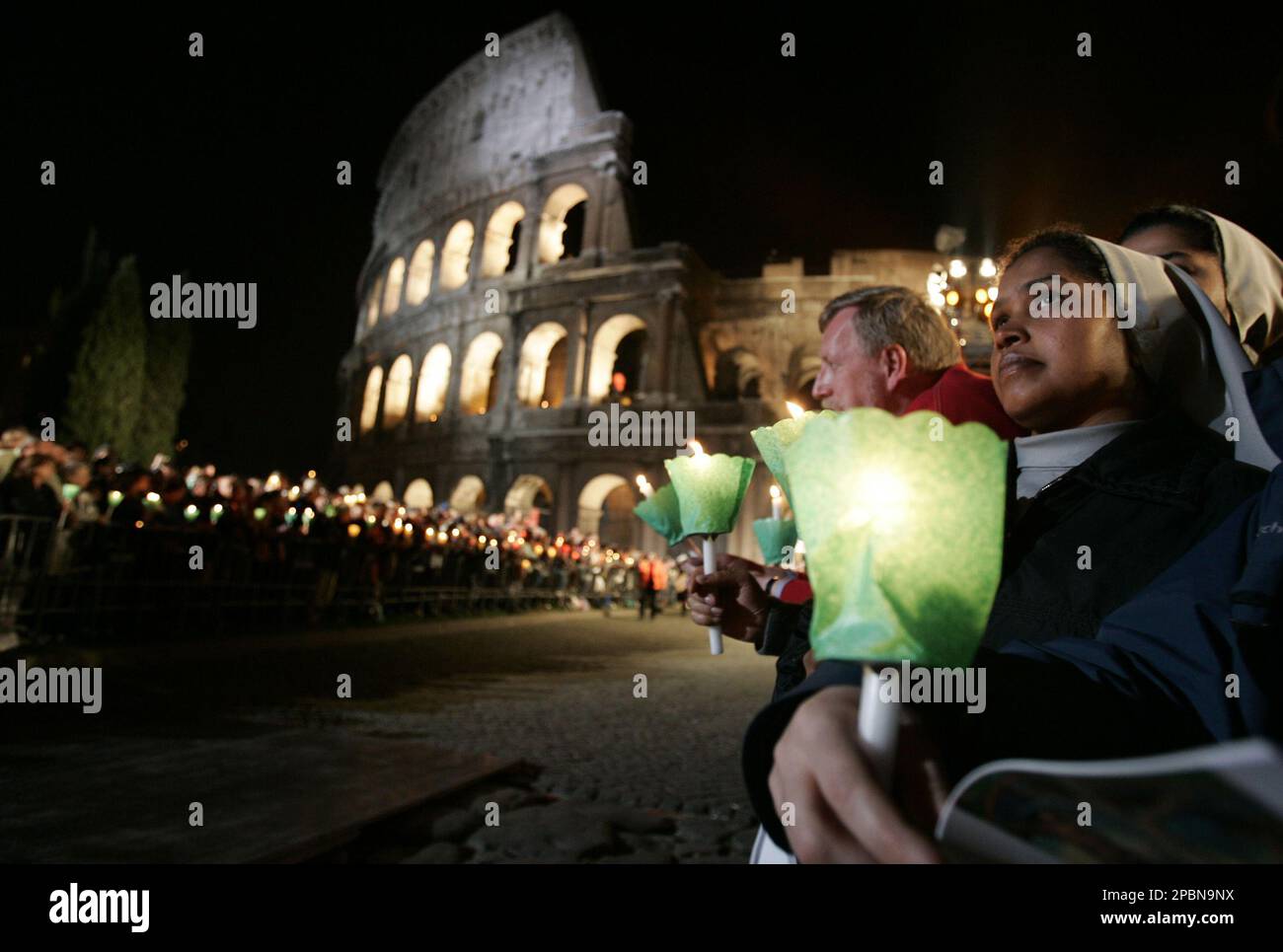 People gather at the foot of Rome's ancient Colosseum for the Via ...