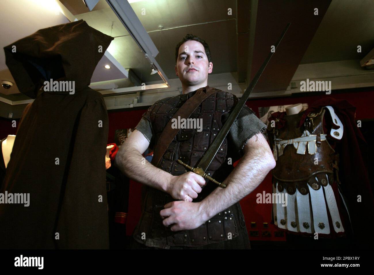 An auction house worker, center, wearing the original outfit of the ...