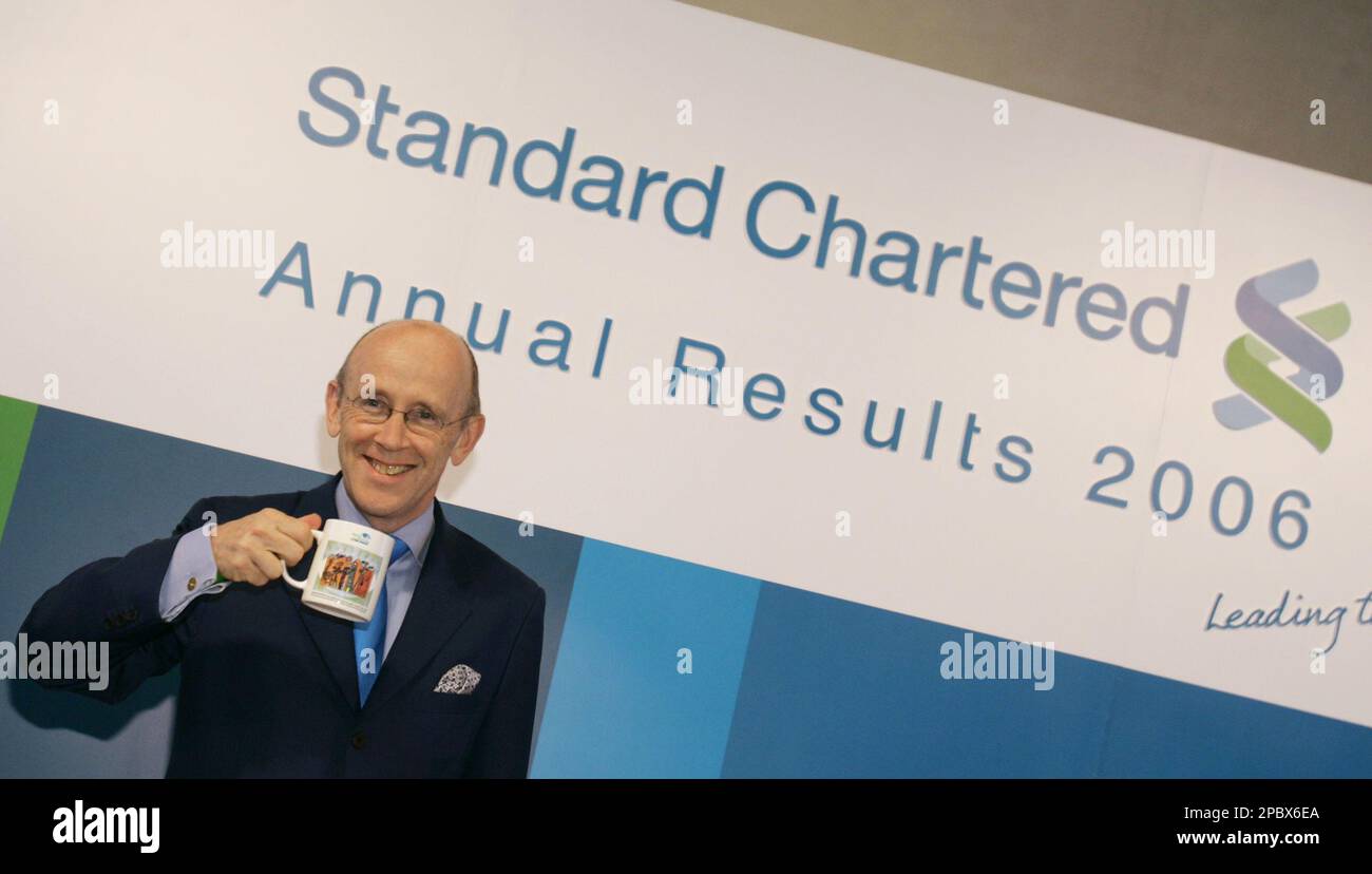 Mervyn Davies, Chairman of Standard Chartered Bank PLC., drinks during ...
