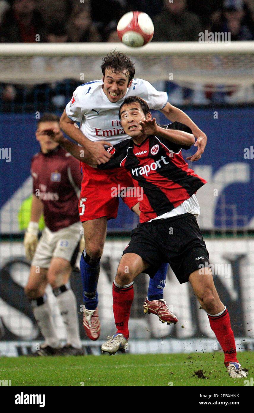 Hamburg's Joris Mathijsen of the Netherlands, left, challenges for the ...