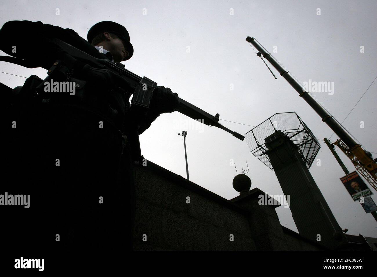 A Police Service of Northern Ireland officer watches British Army ...