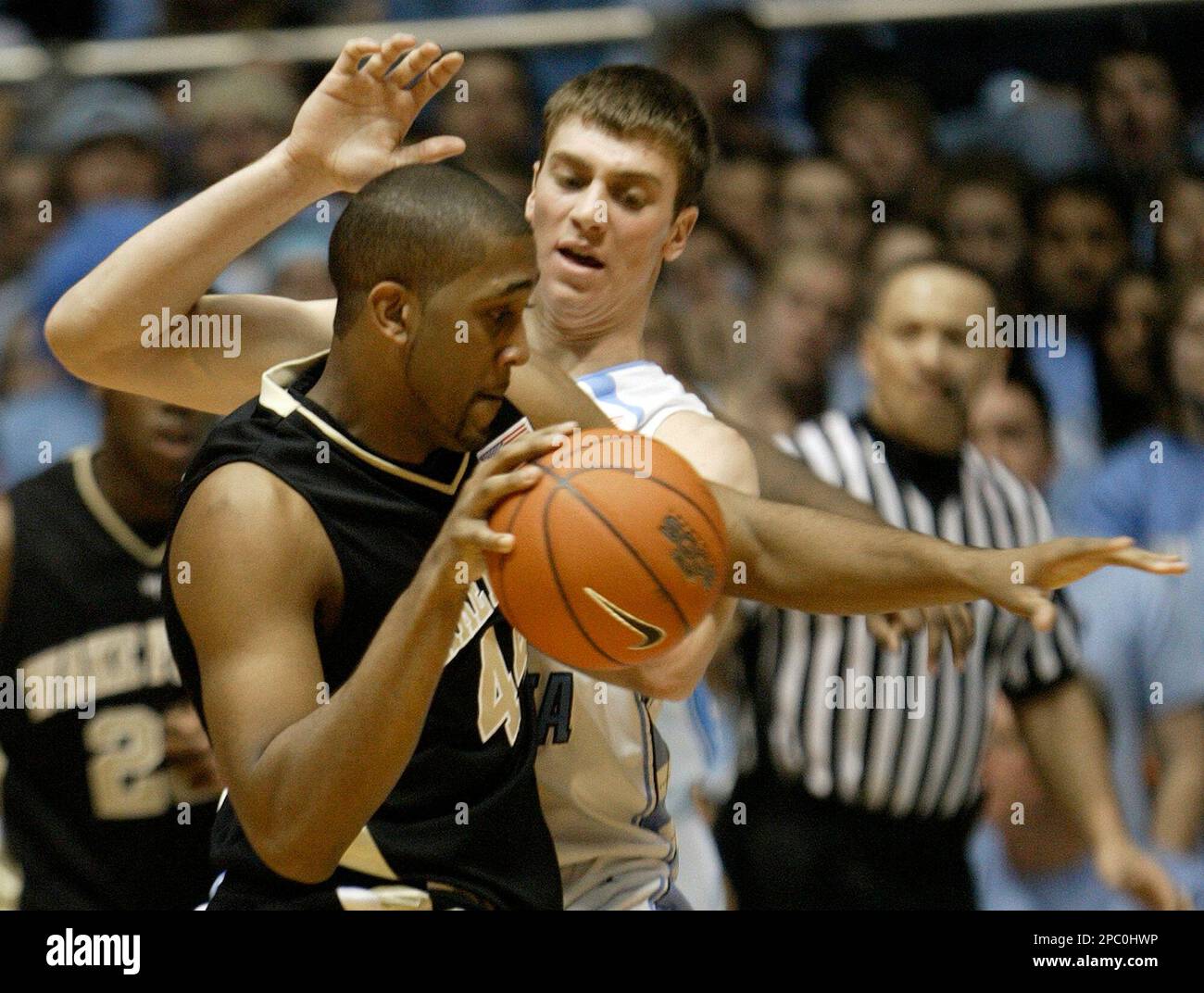 North Carolina's Tyler Hansbrough, rear, guards Wake Forest's David Weaver during the first half ...