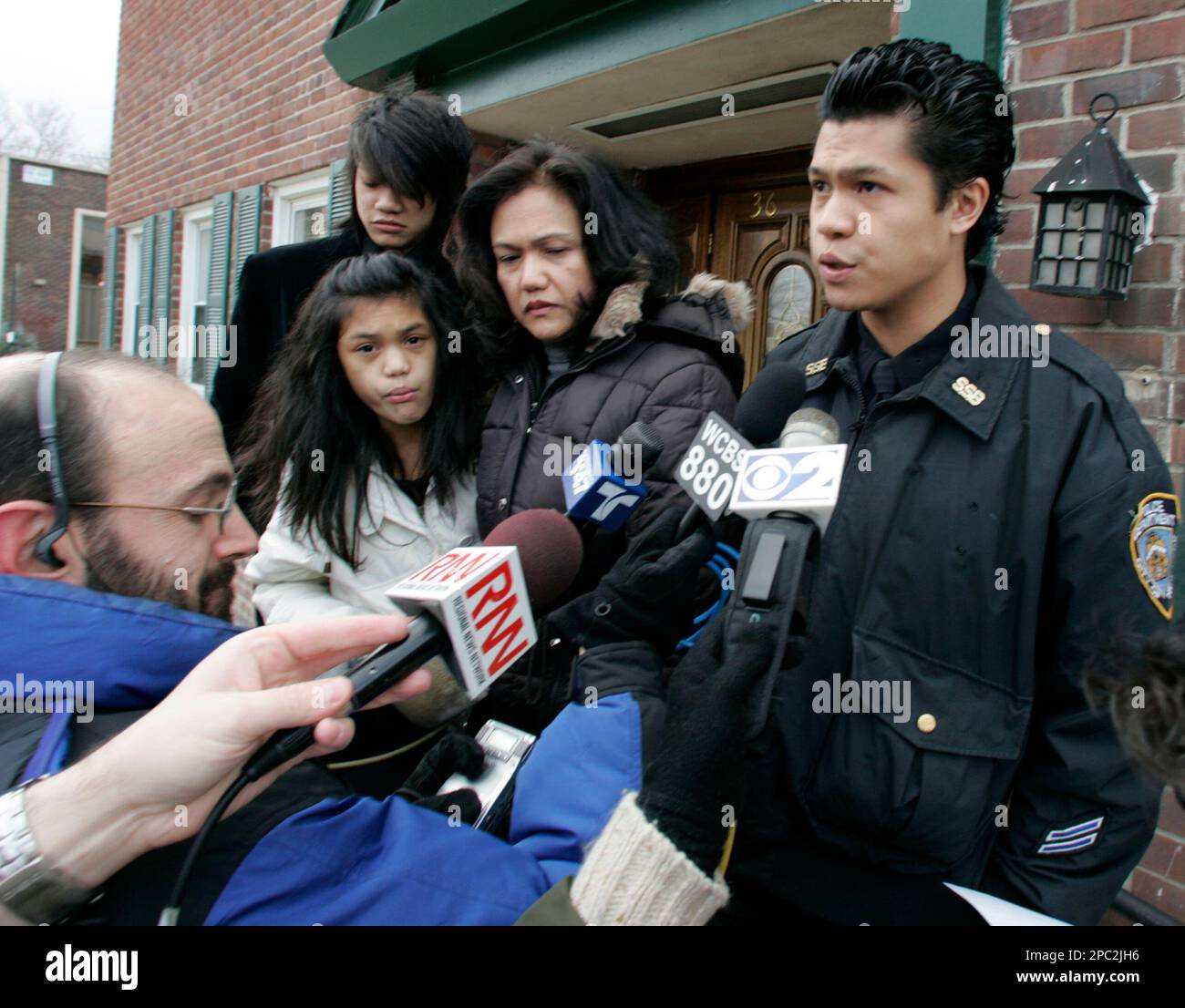Ceasar Borja answers questions during a news interview as his mother ...