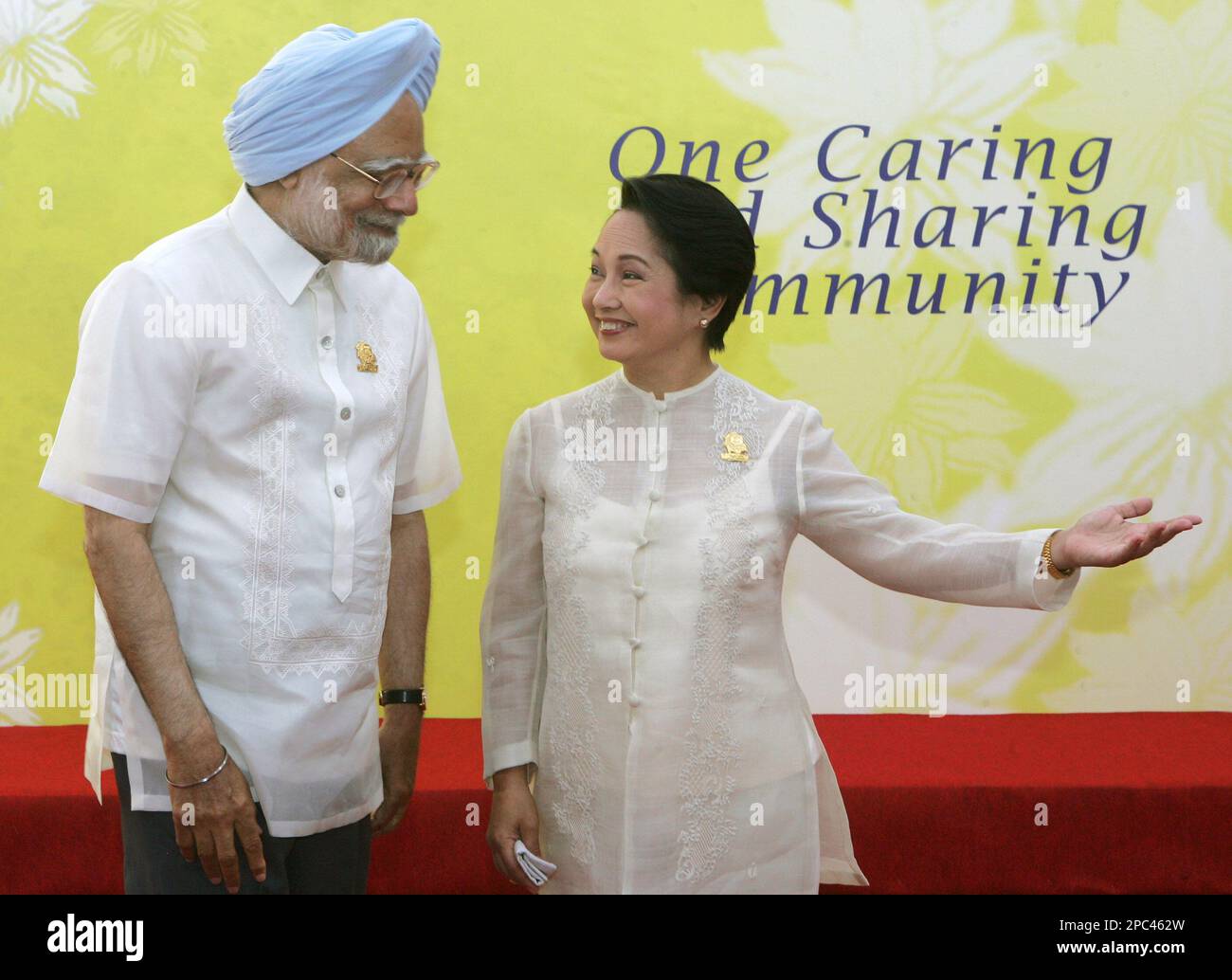 Indian Prime Minister Manmohan Singh, left, is shown the way by ...