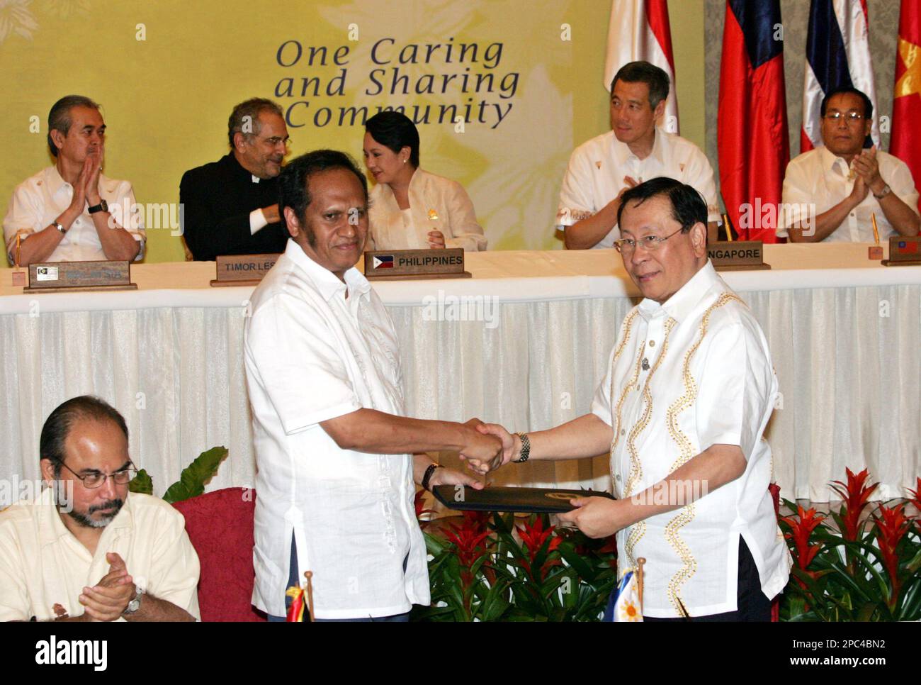 Philippine Foreign Affairs Secretary Alberto Romulo, right, accepts ...