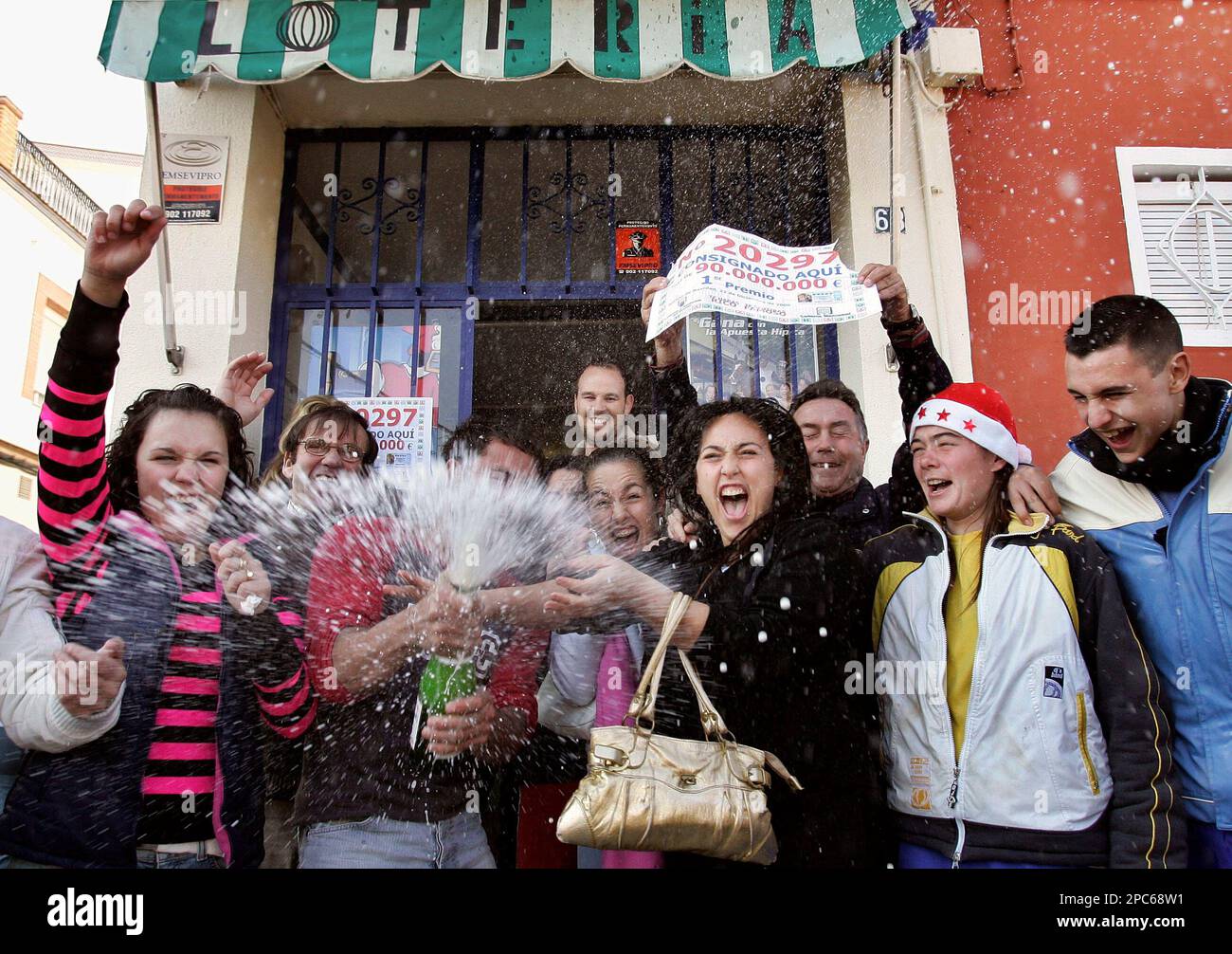 People celebrate outside a lottery office after winning a portion the ...