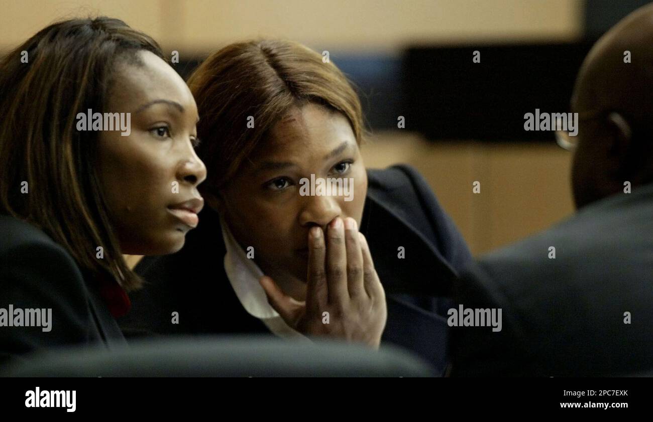 Tennis stars Venus, left, and Serena Williams talk with their attorney ...
