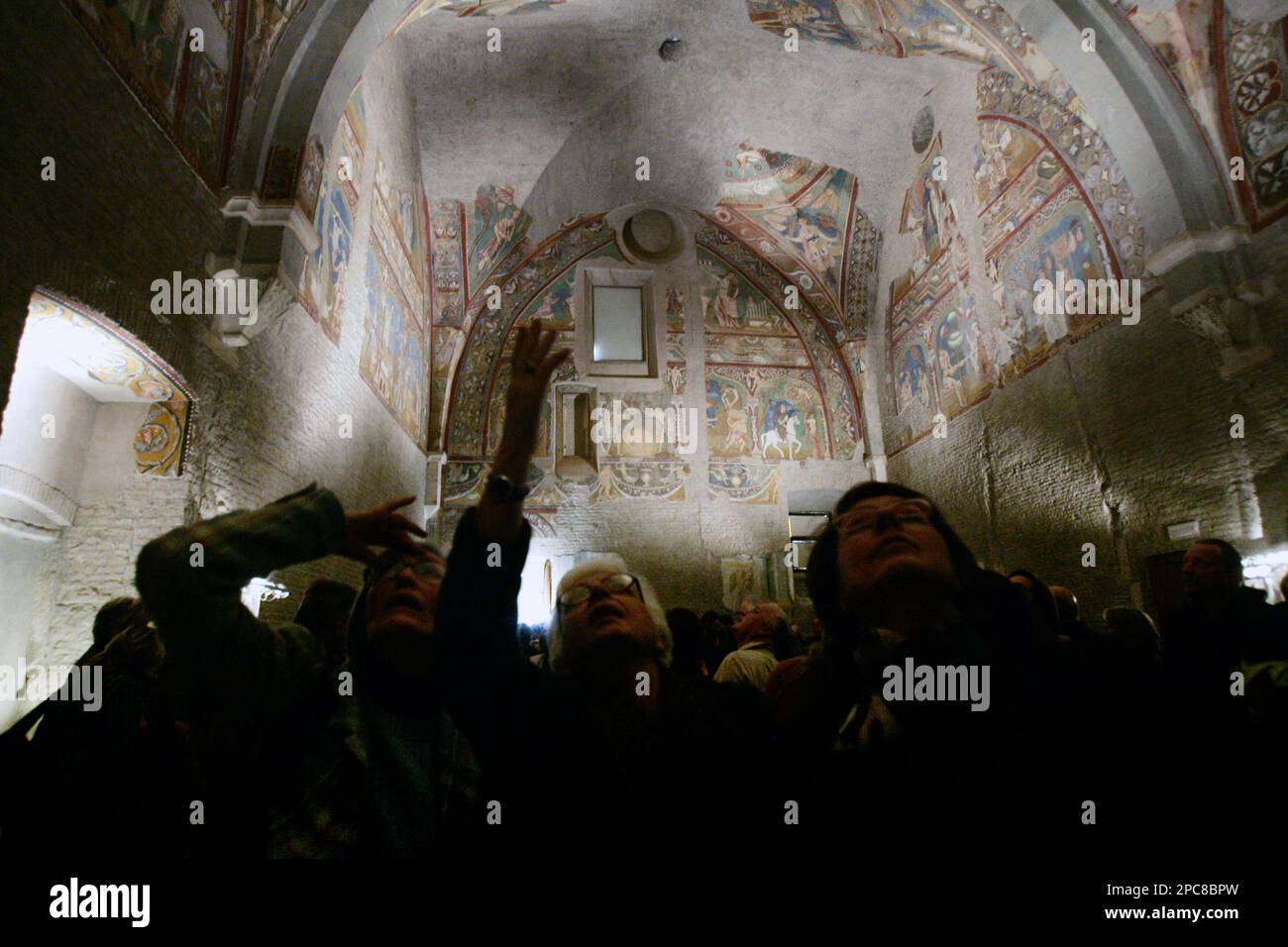 People admire the newly restored 13th century frescoes of the Gothic ...