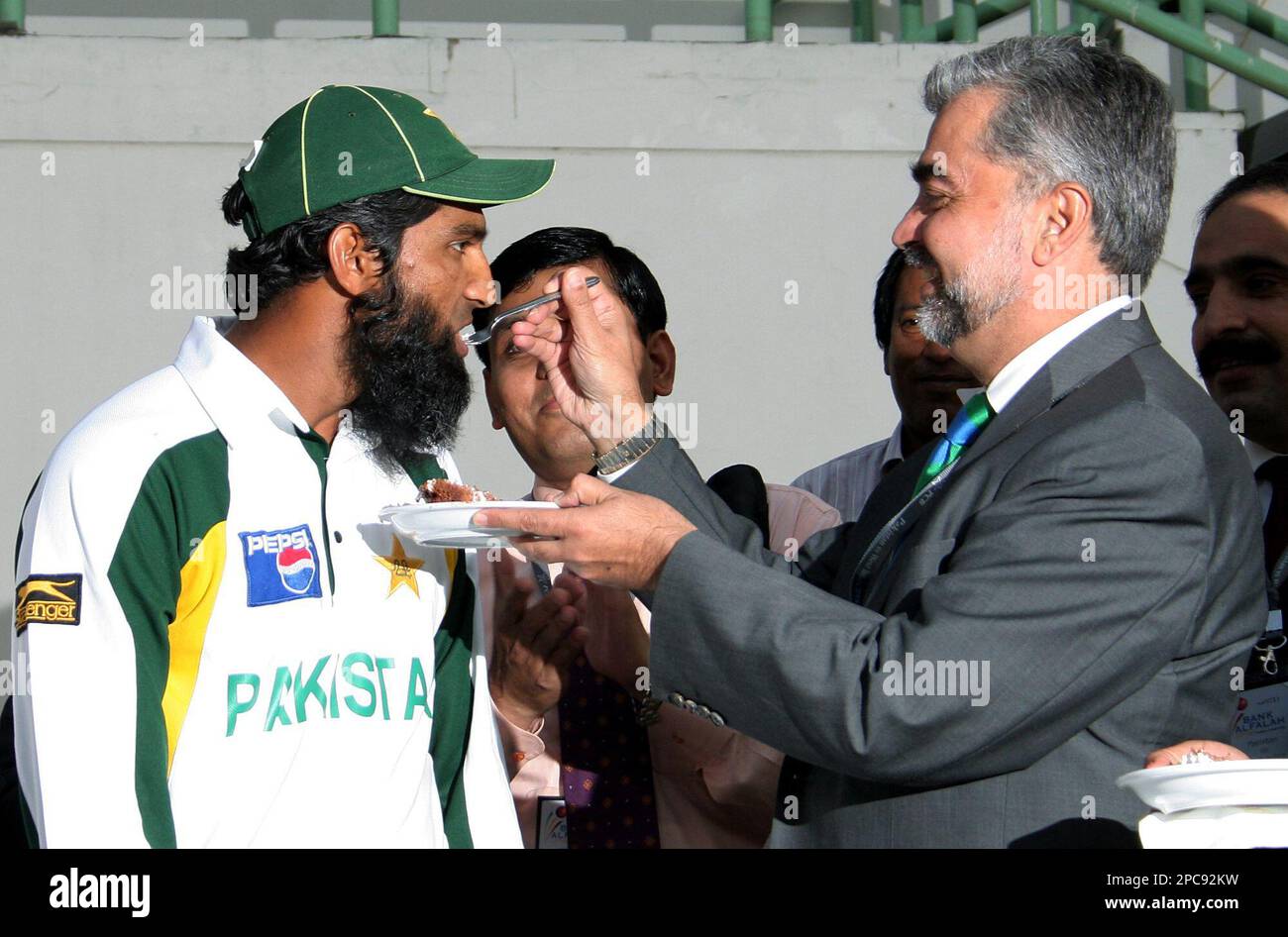 Chairman of the Pakistan Cricket Board, Naseem Ashraf, right, offers ...