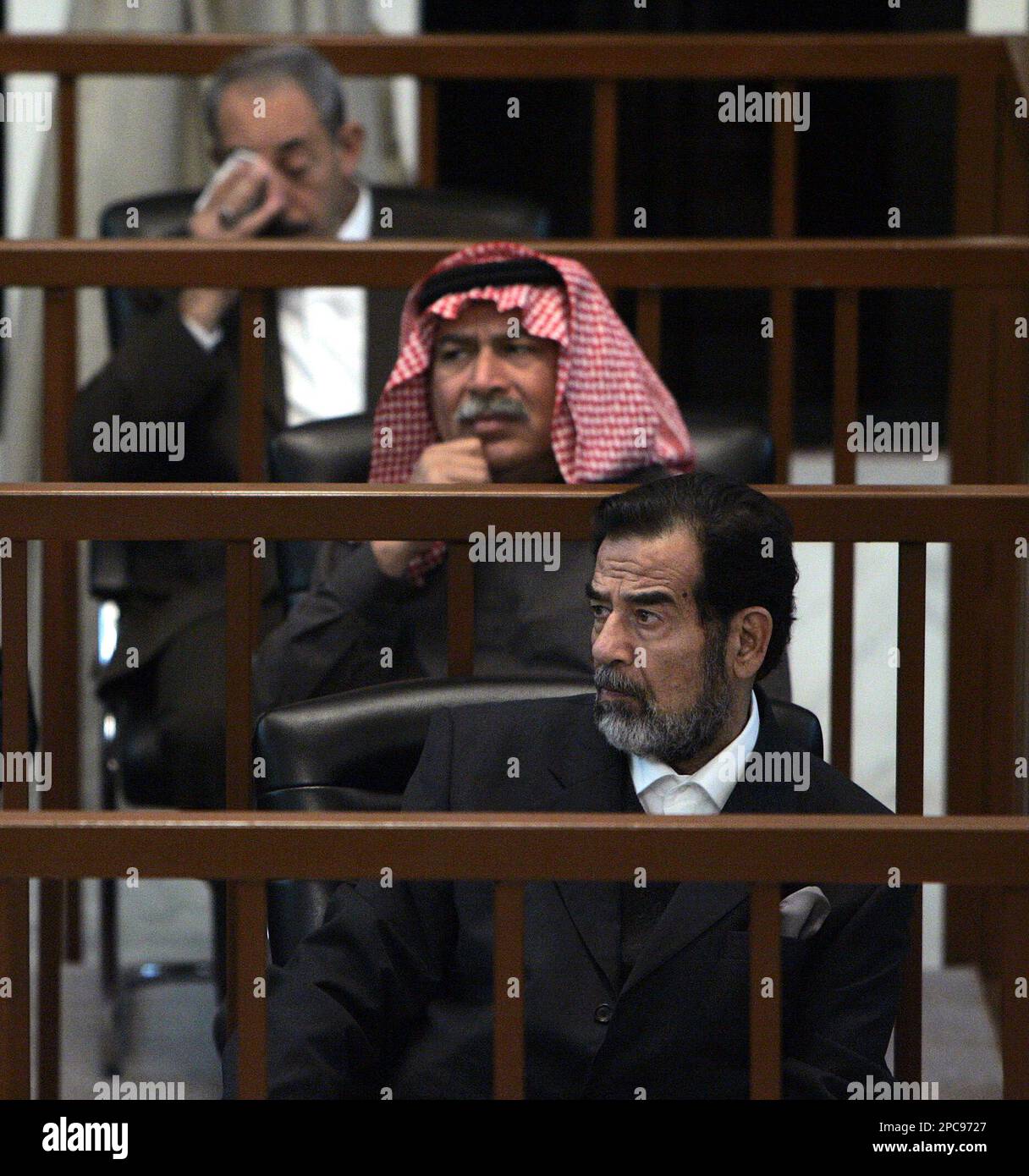 Saddam Hussein, foreground, along with co-defendant Sultan Hashim Ahmad ...