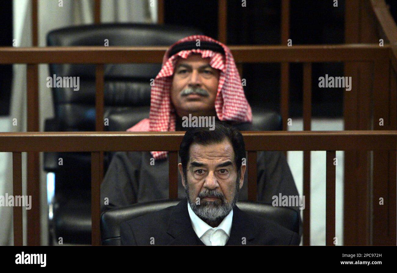 Saddam Hussein, foreground, along with co-defendant Sultan Hashim Ahmad ...