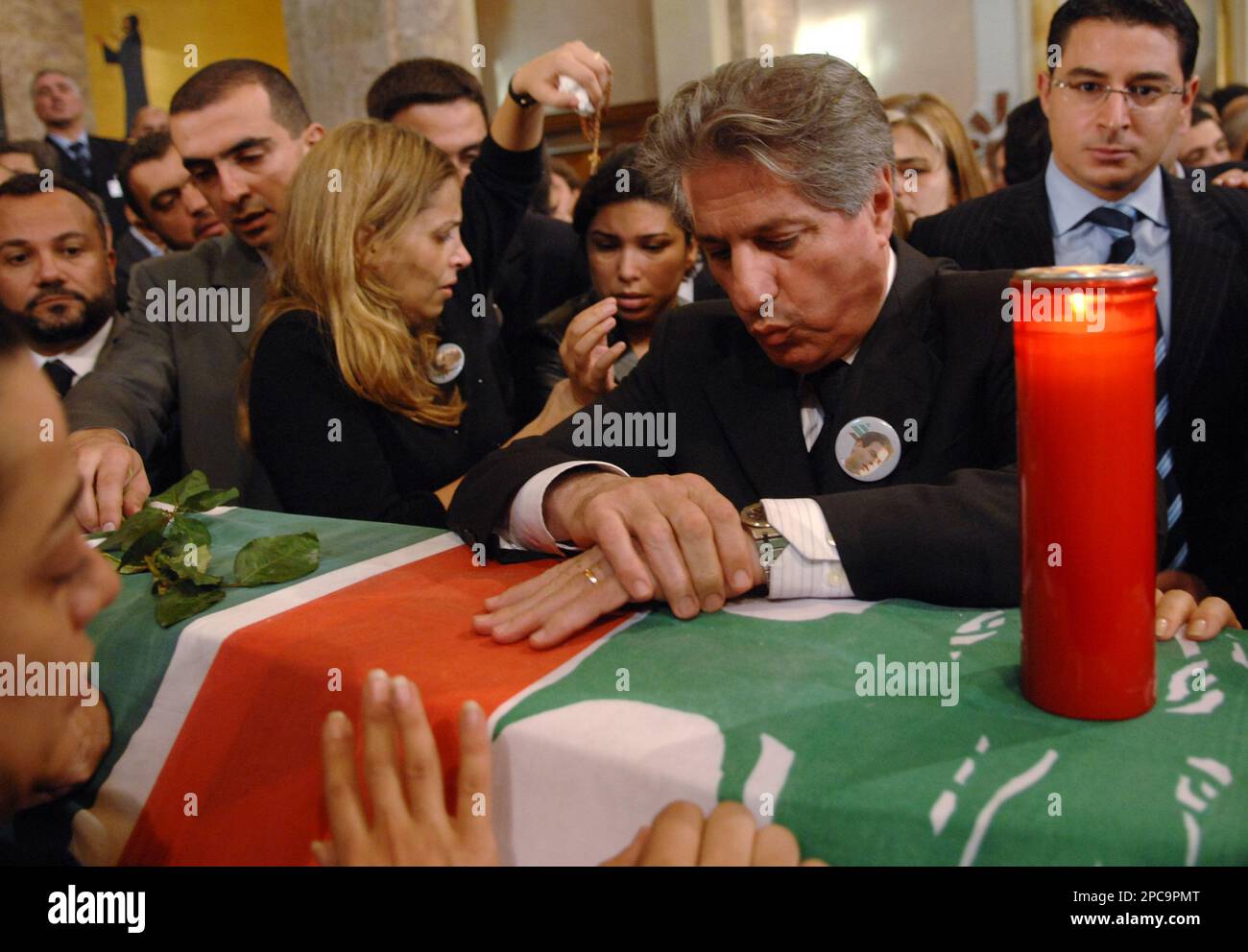Former Lebanese President Amin Gemayel mourns over the coffin of his ...