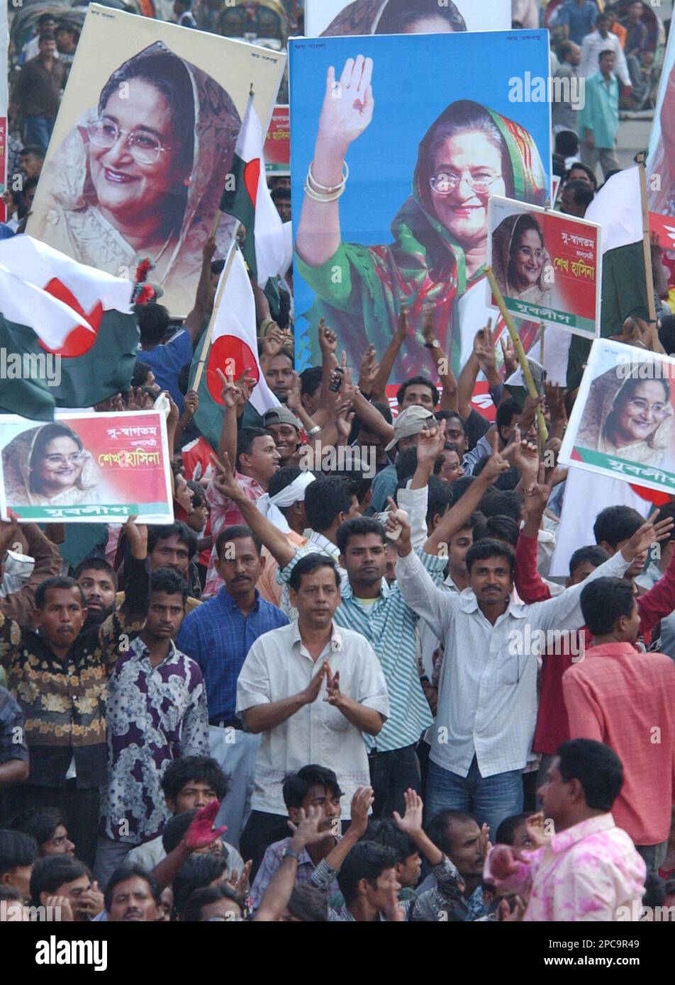 Cheering Bangladesh Awami League supporters carry portraits of their ...