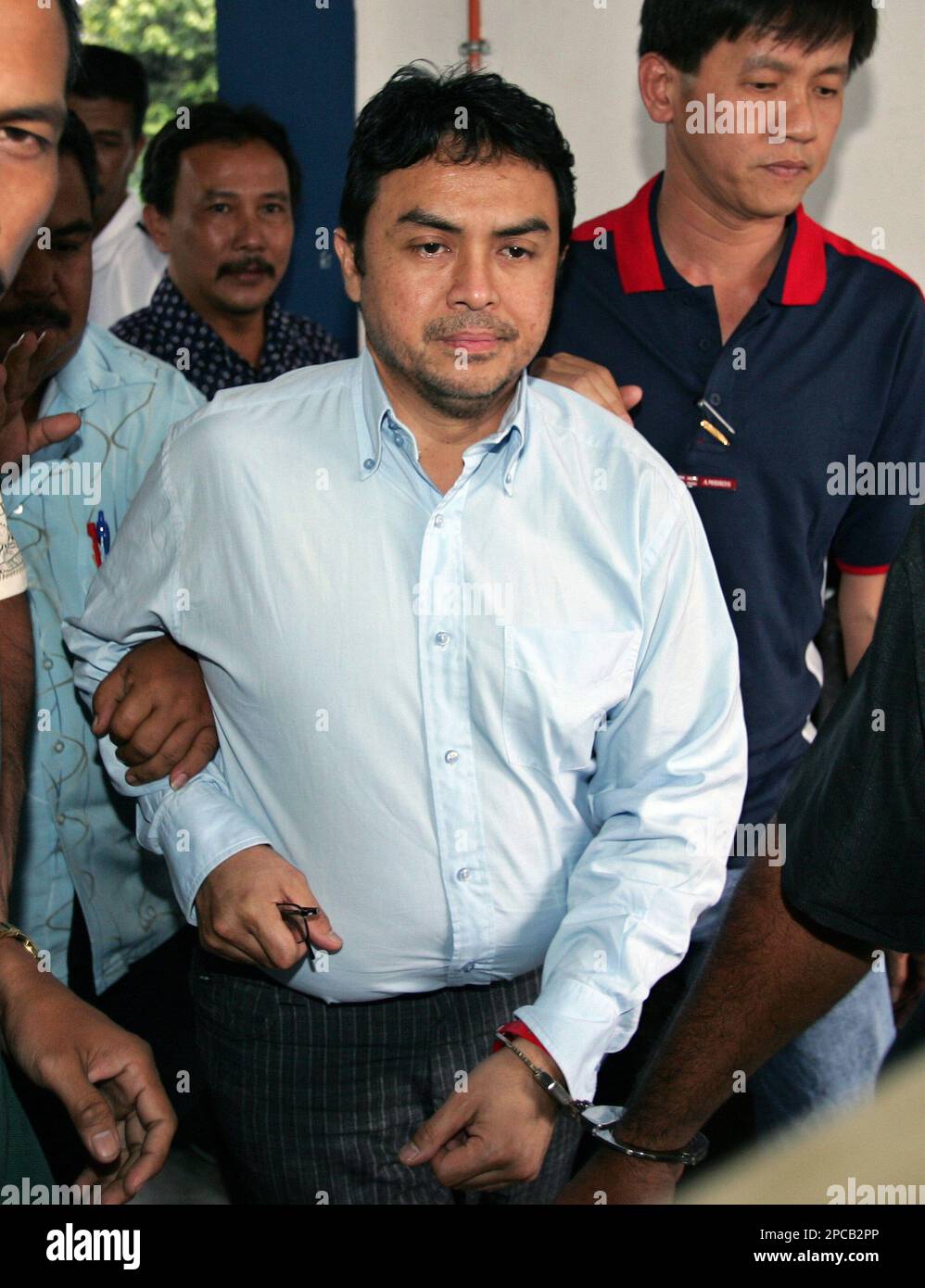 Abdul Razak Baginda, center, is escorted by police officers upon his ...