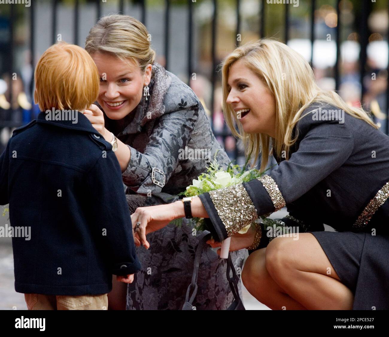 Dutch Princess Maxima, right, and Belgium Princess Mathilde greet an unidentified boy while ...
