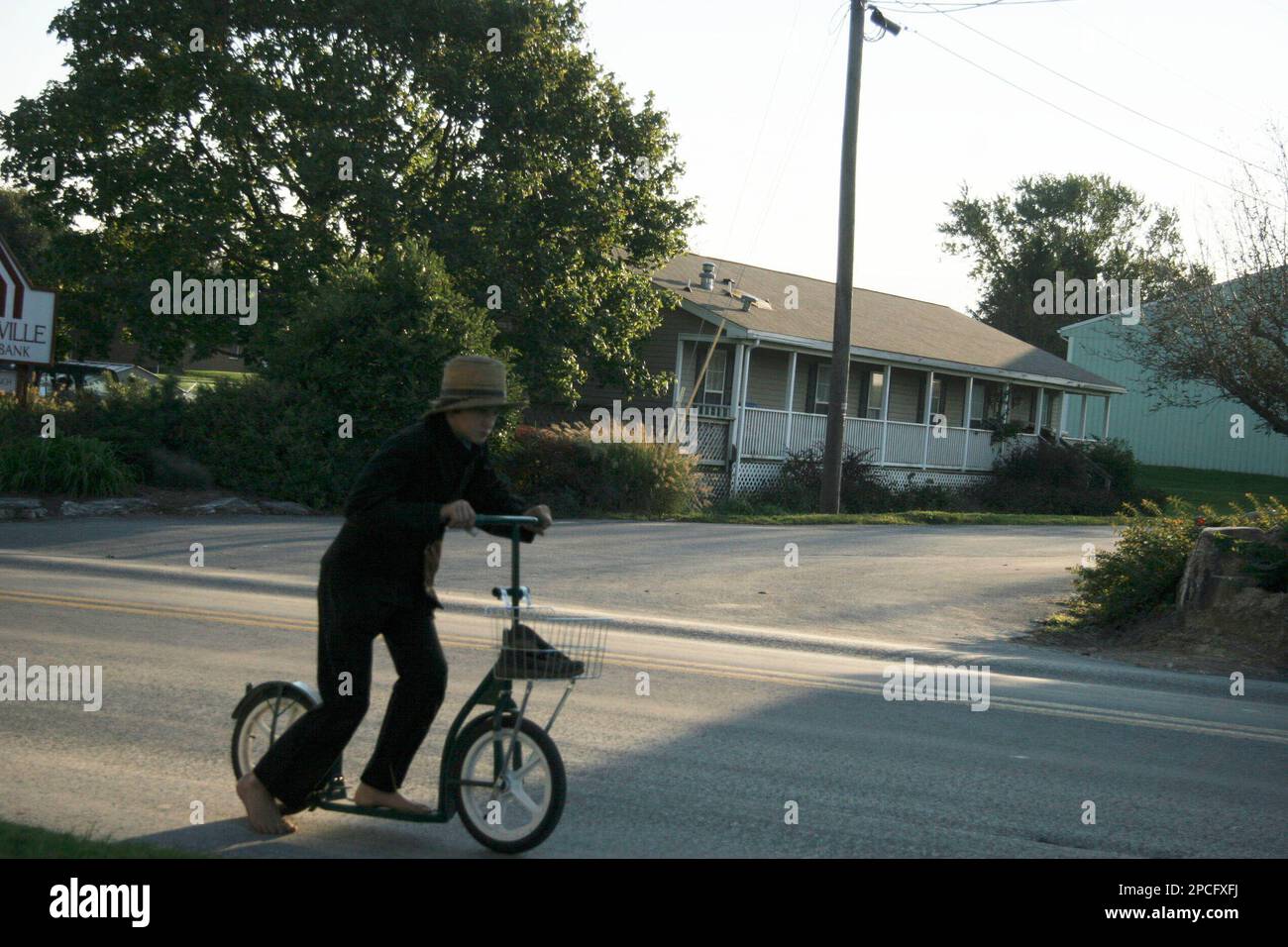A boy passes the residents of Charles Carl Roberts IV in Nickel Mines ...