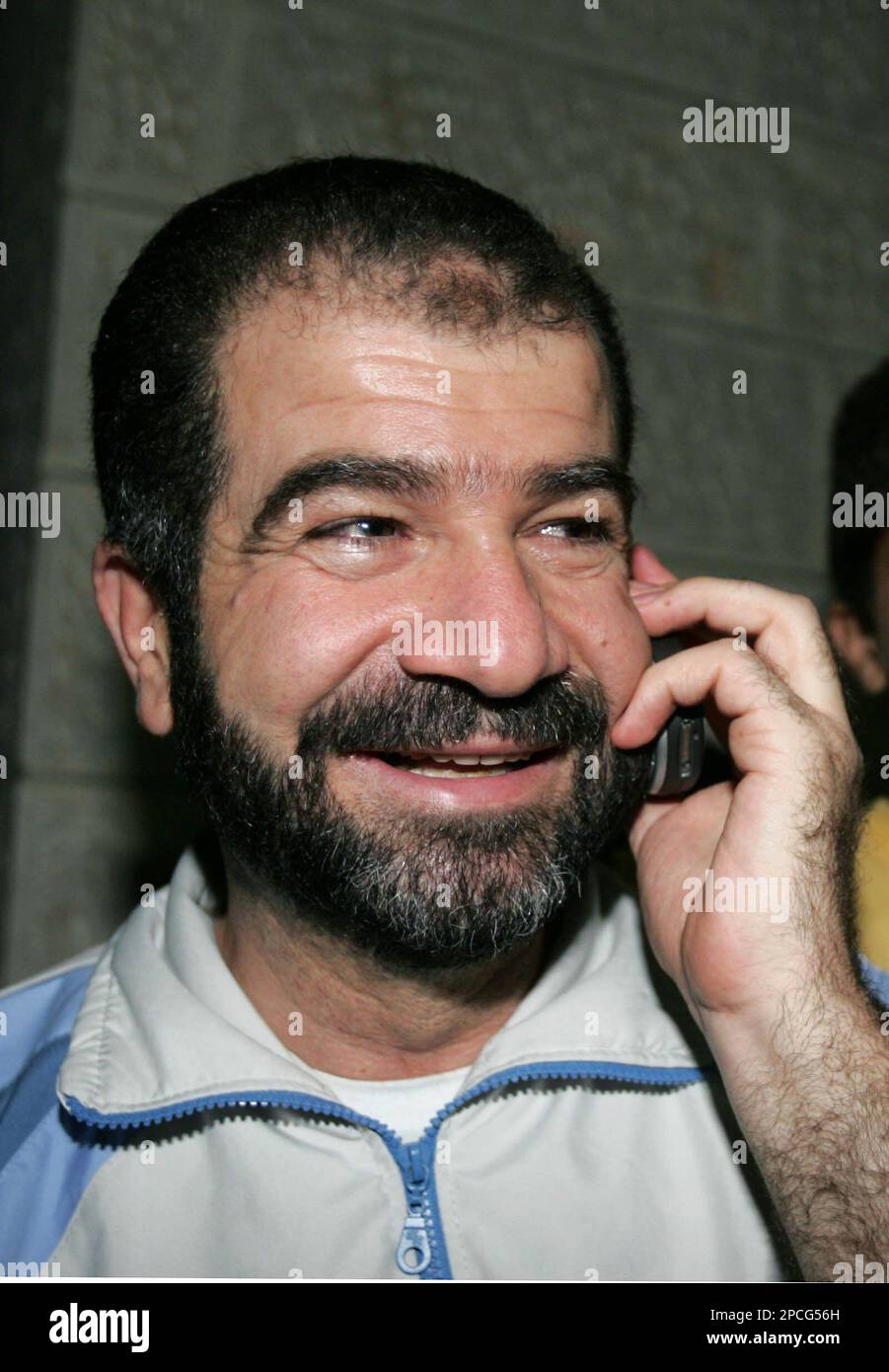 Jordanian lawmaker Ali Abul Sukkar speaks on a mobile phone in his home ...