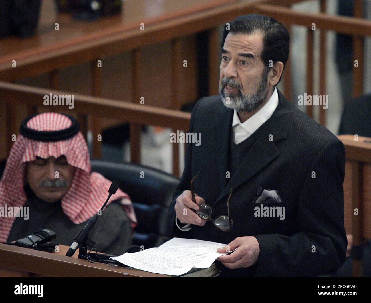 Saddam Hussein testifies during his genocide trial, inside the ...