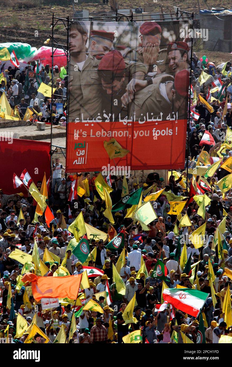 Hezbollah supporters wave Hezbollah, Iranian and Lebanese parties ...