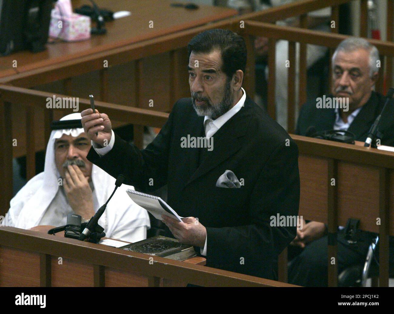 Former Iraqi President Saddam Hussein testifies during his trial on ...