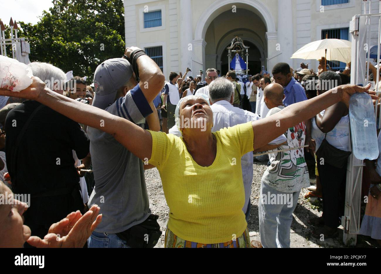 A faithful woman prays before a procession in honor to La Virgen de ...