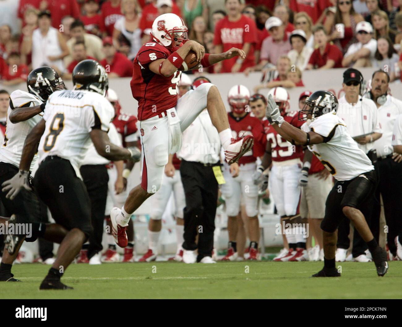 North Carolina State quarterback Marcus Stone (9) gets airborne as he ...