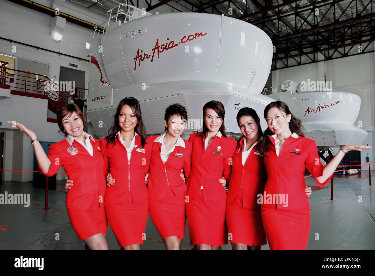 Stewardess from Malaysia, Thailand and Indonesia gestures as they ...
