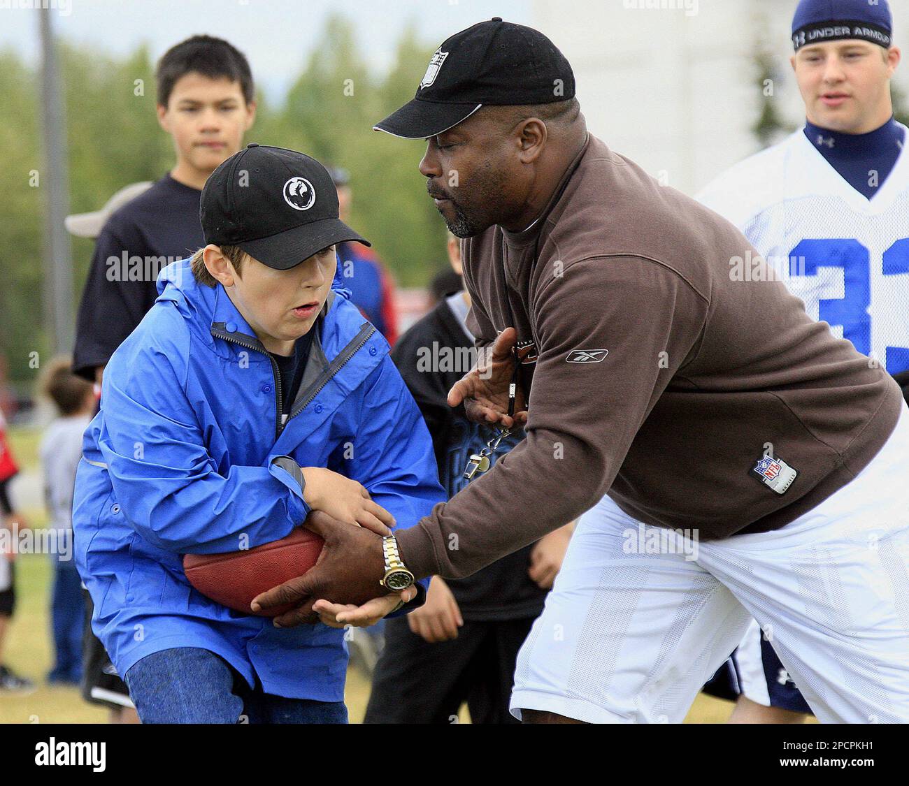 Retired Los Angeles Raiders running back Dokie Williams gives the ball ...
