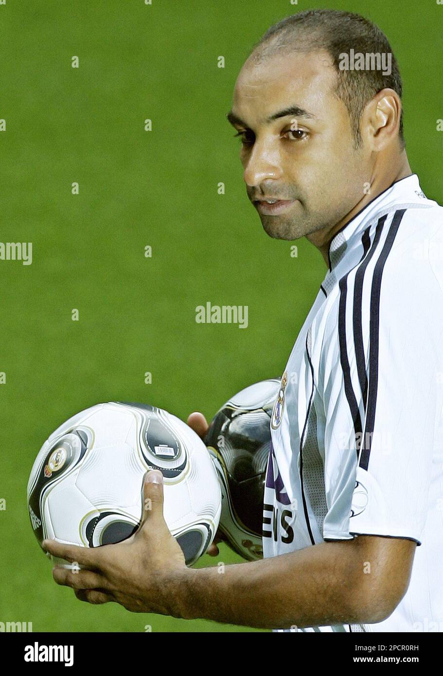Former Juventus player Emerson of Brazil carries two soccer balls onto ...