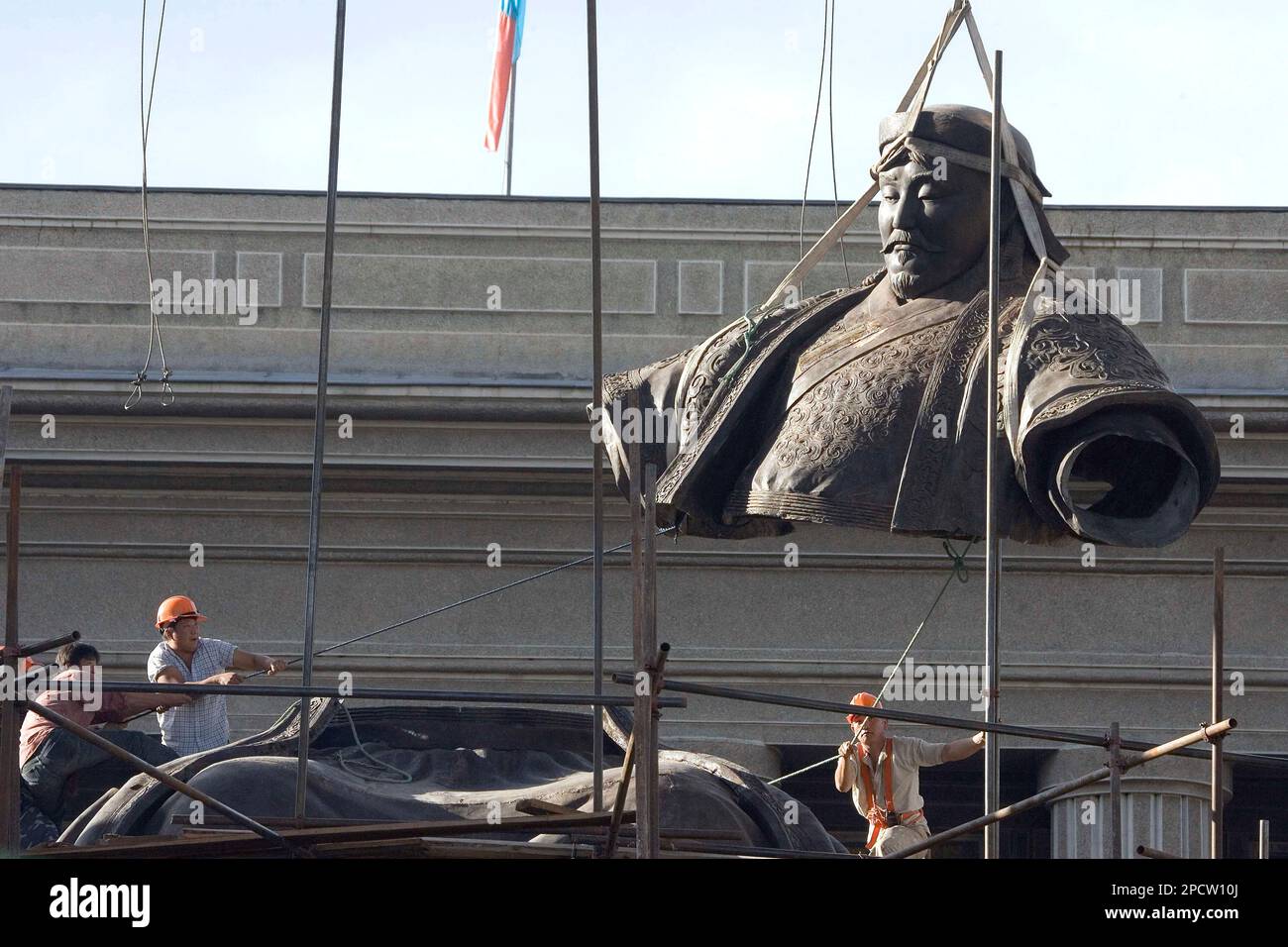 Workers installing a giant statue of Genghis Khan outside the Mongolian ...
