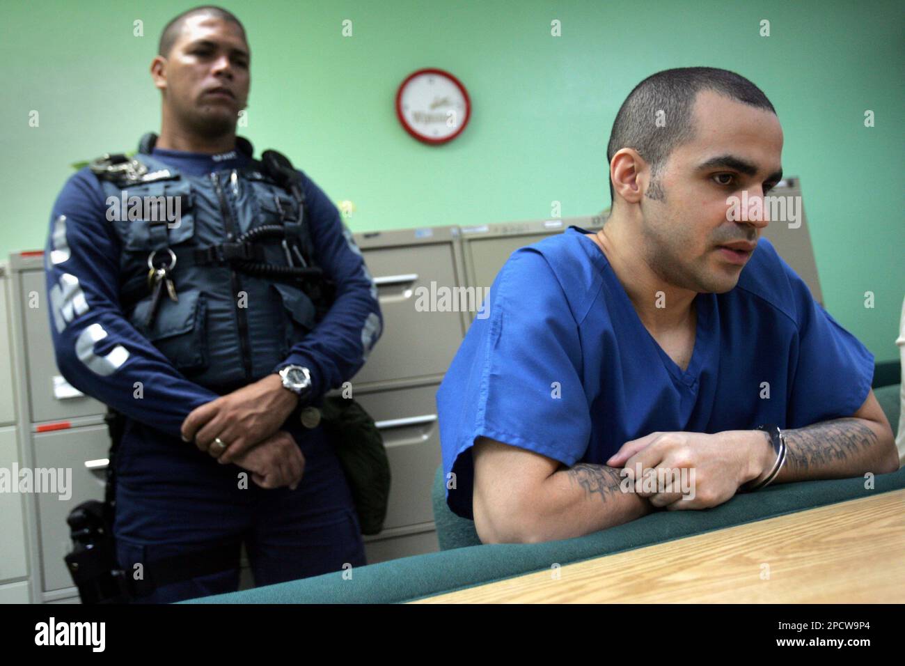 Watched by a prison guard, Puerto Rican detainee Juan Martinez Cruz ...