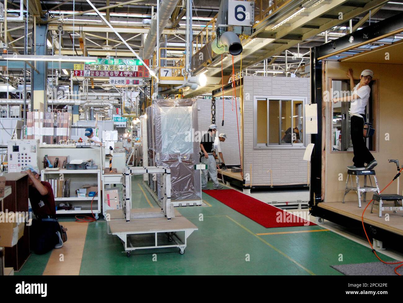 Workers are busy in cubicles that are parts of homes, tcomplete with ...