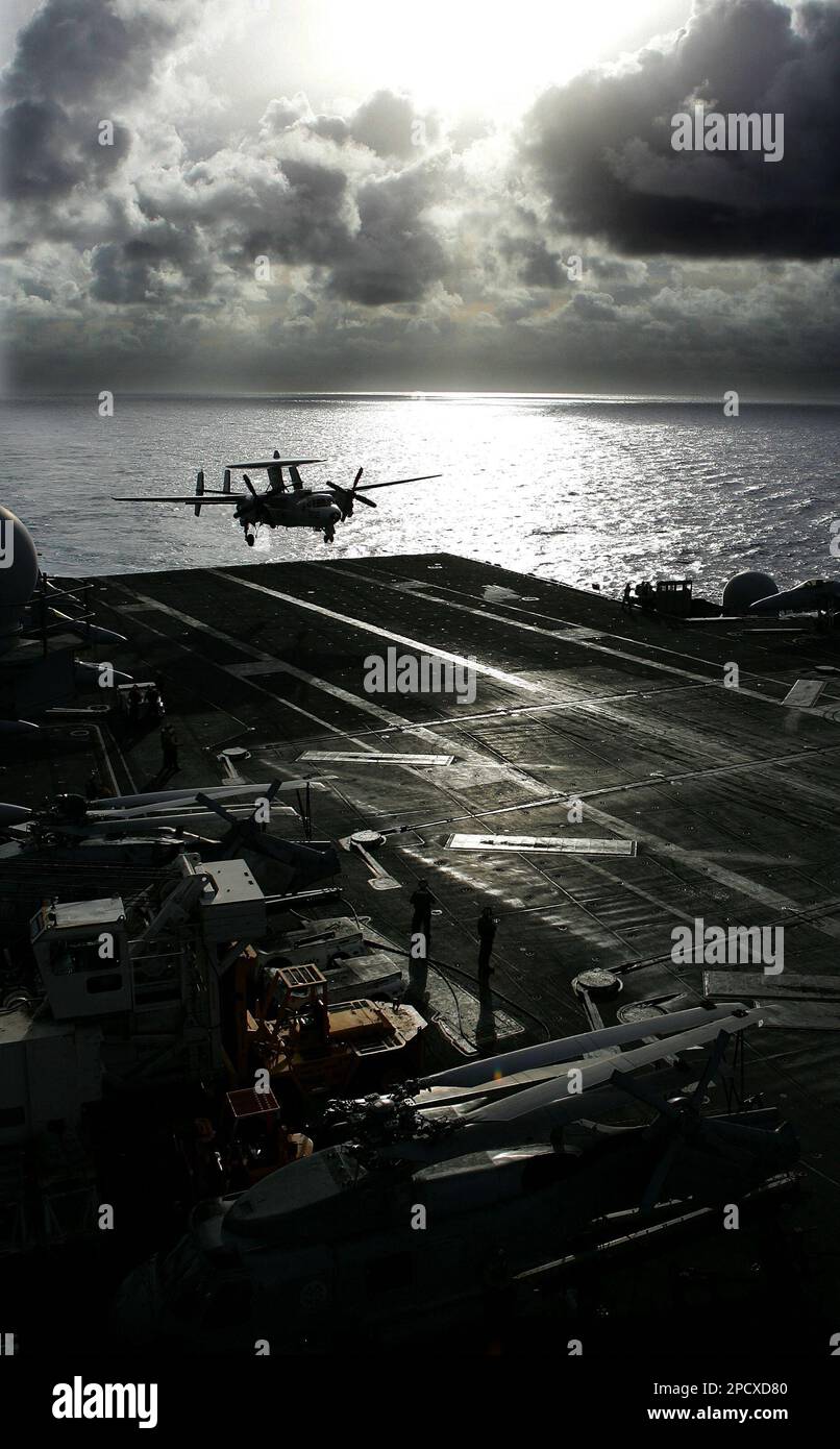 A U.S. Navy E2C Hawkeye approaches the USS Ronald Reagan for landing on ...