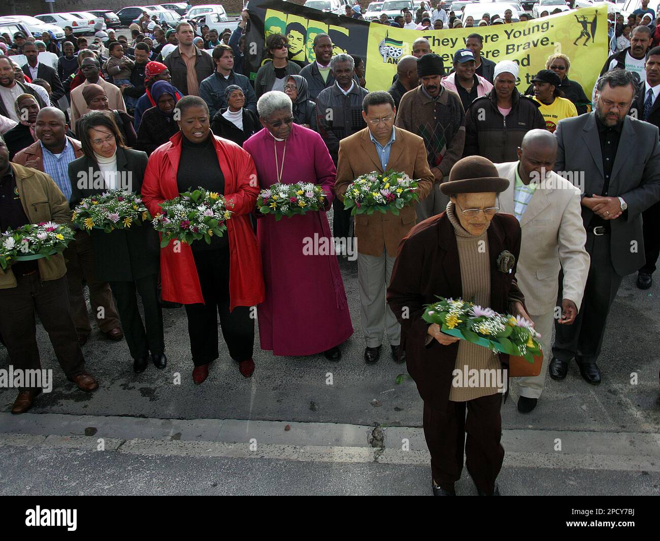 Rebecca Truter, front, carries a wreath to the spot wher her son ...