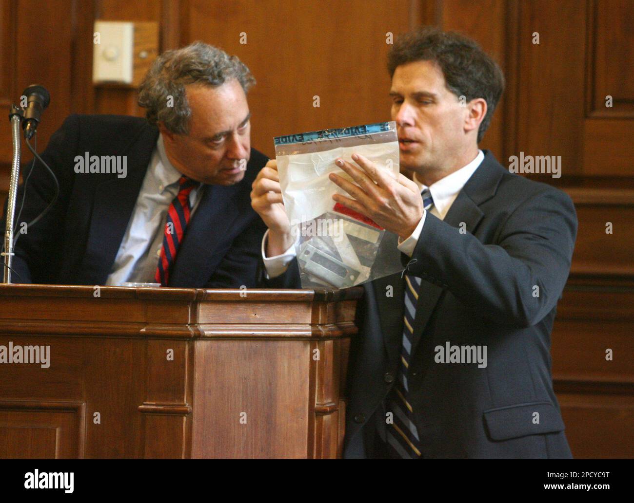 Marc Tobias, identified as a lock expert, examines a lock mechanism ...